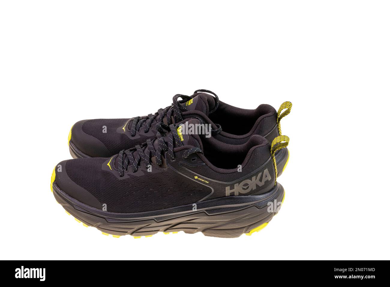 Close up view of black yellow Hoka sneakers isolated on white ...