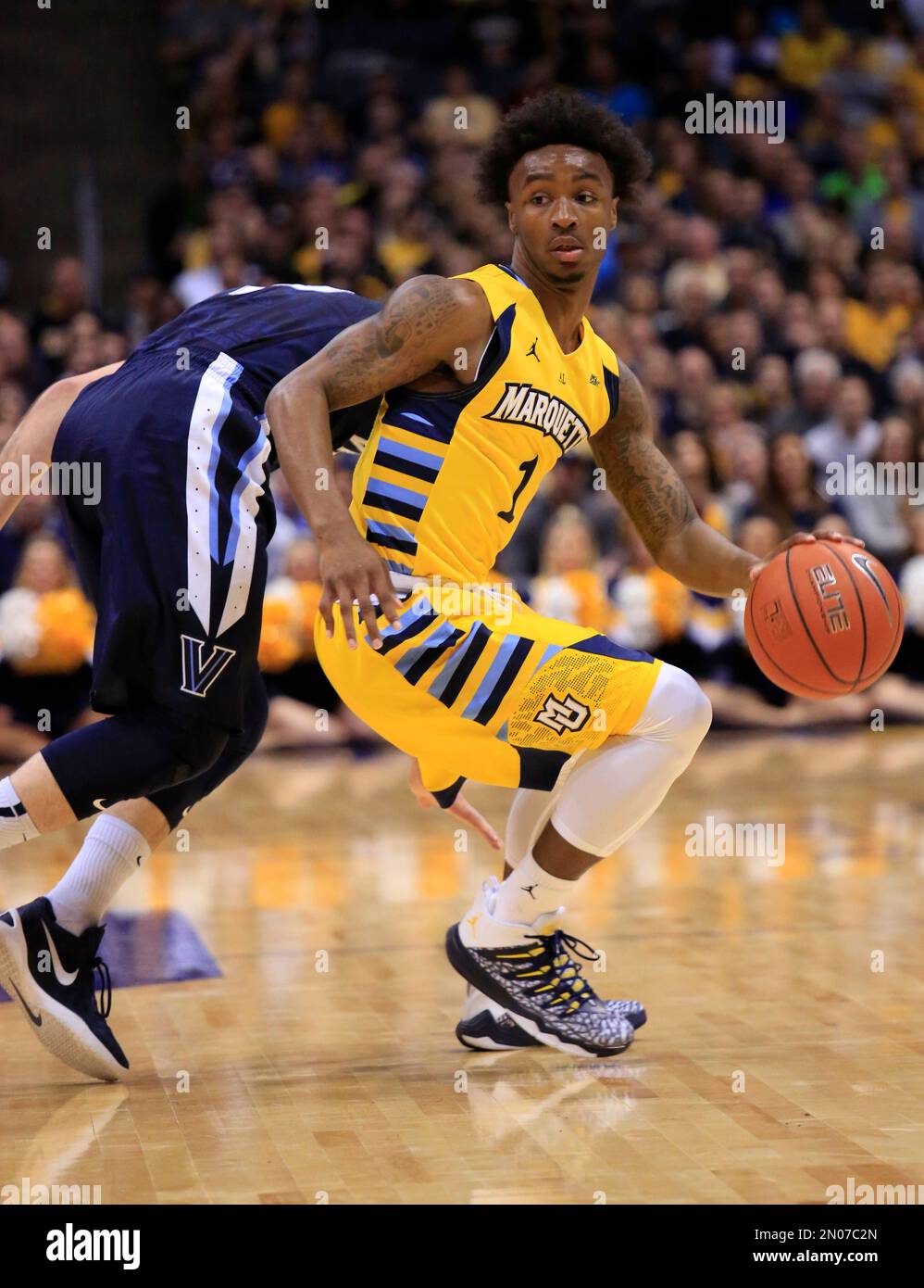 Marquette guard Duane Wilson, right, drives around Villanova during the ...