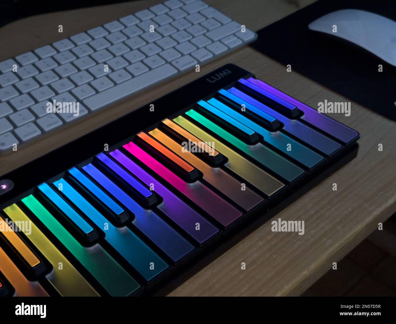 a detail of a colourful, illuminated, computer music, midi keyboard ...