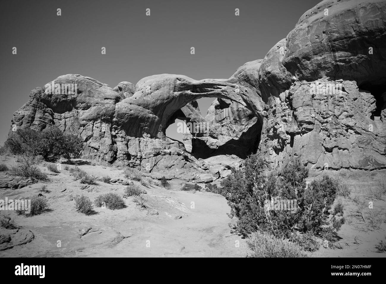 A landscape grayscale scene of Double O Arch in Arches National Park ...