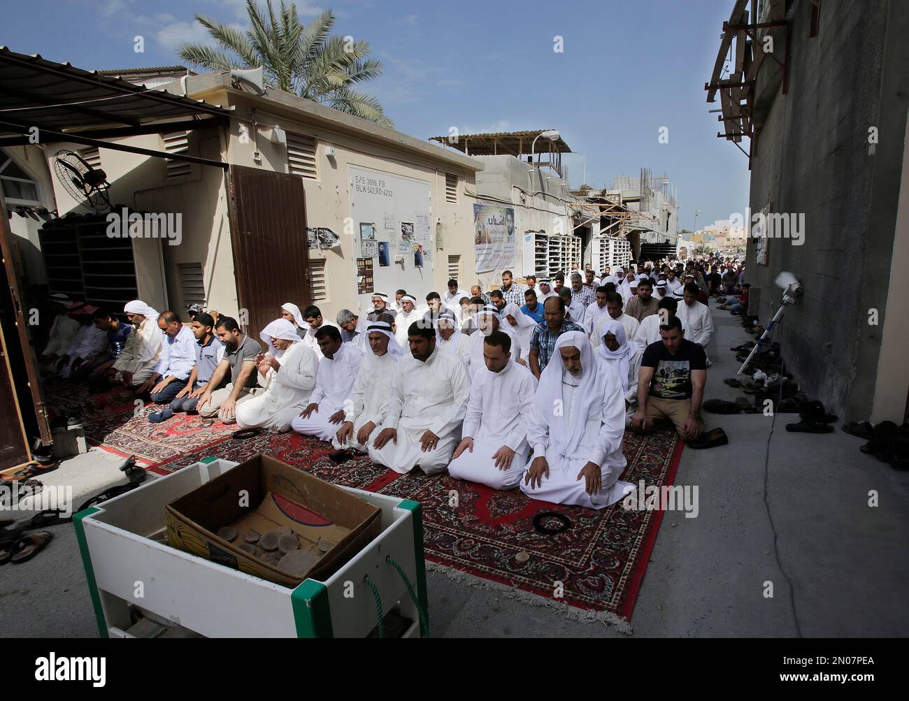 Bahraini men pray in an overflow area outside a Shiite mosque in Diraz ...