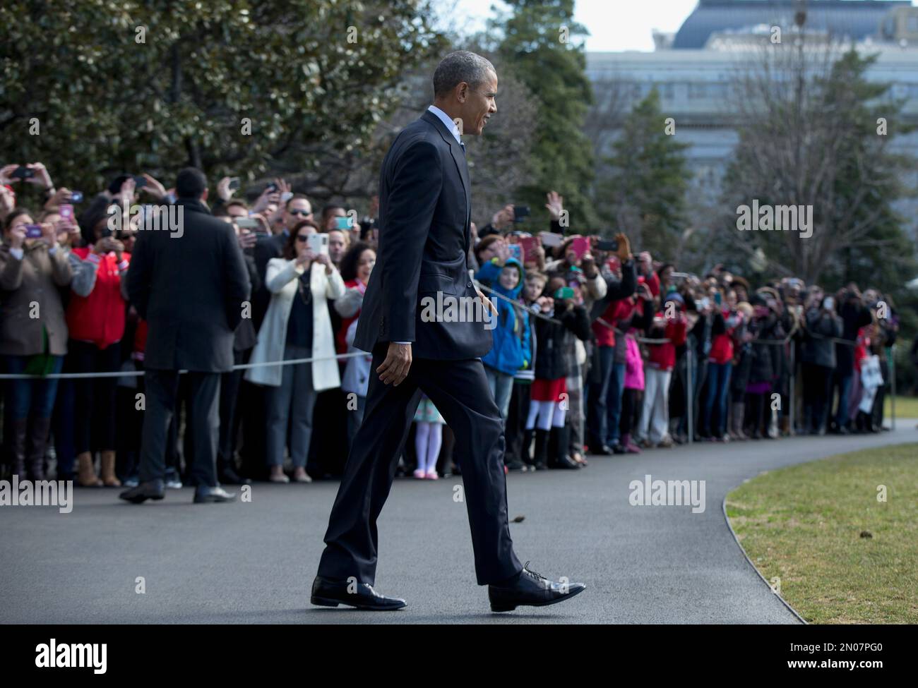 President Barack Obama walks to board the Marine One on the South Lawn ...