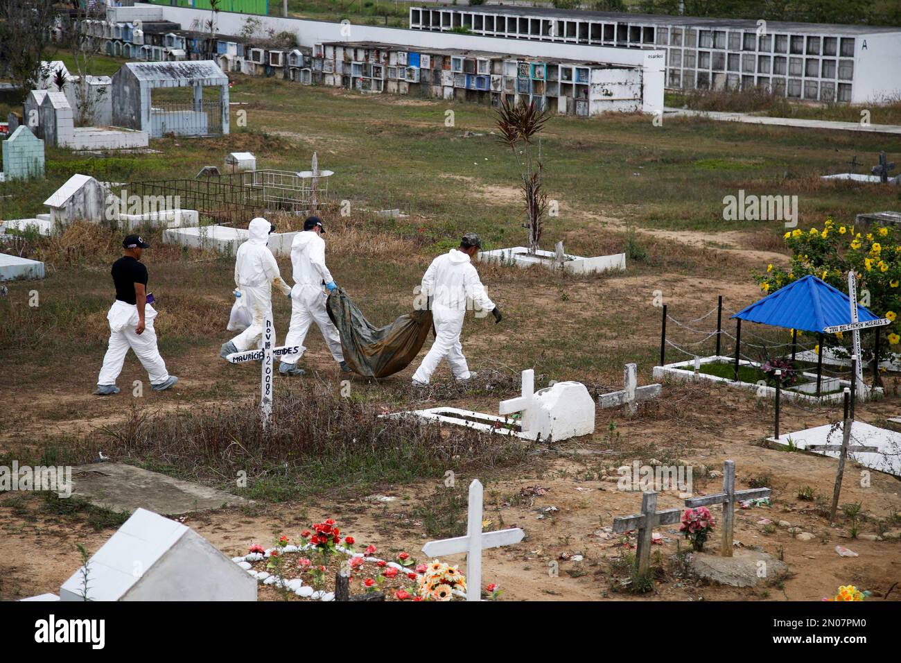 In this Wednesday, Feb. 24, 2016 photo, forensic workers carry an ...