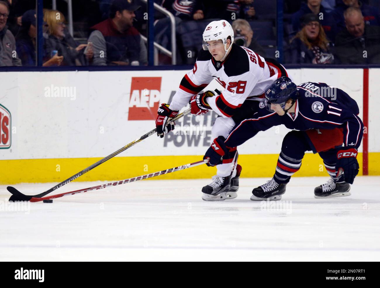 New Jersey Devils' Damon Severson, left, works for the puck against ...