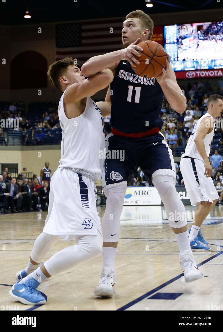 Gonzaga forward Domantas Sabonis stands high over San Diego forward Alex Floresca during the ...