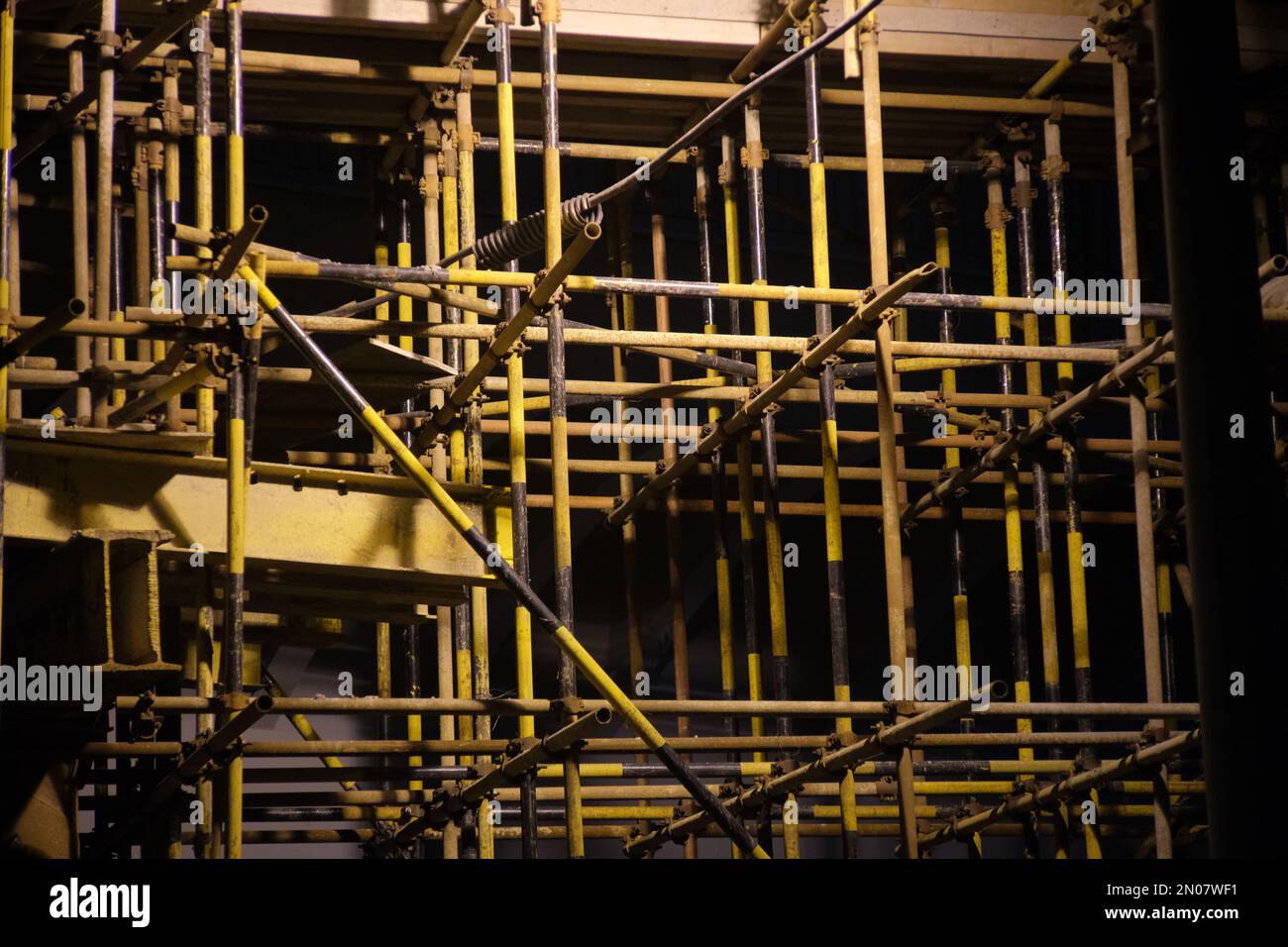 Yellow scaffolding under street lamp light at night Stock Photo - Alamy