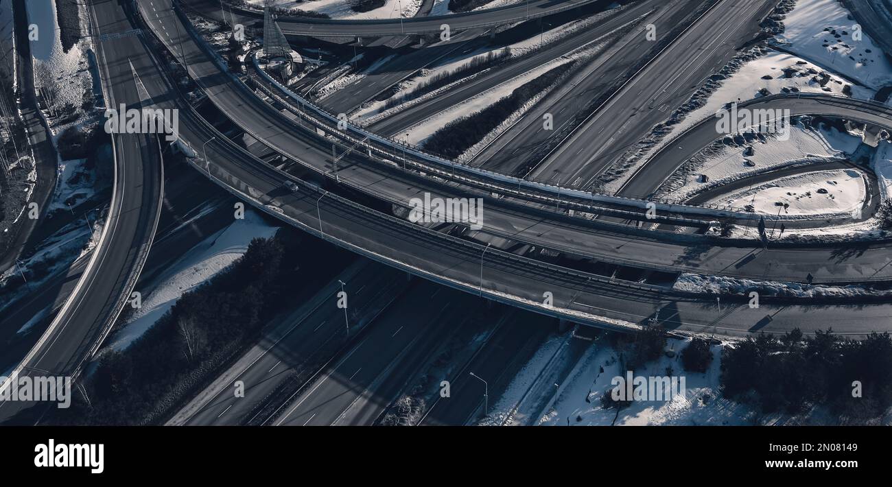 Aerial view of a freeway intersection Snow-covered in winter. Busy ...