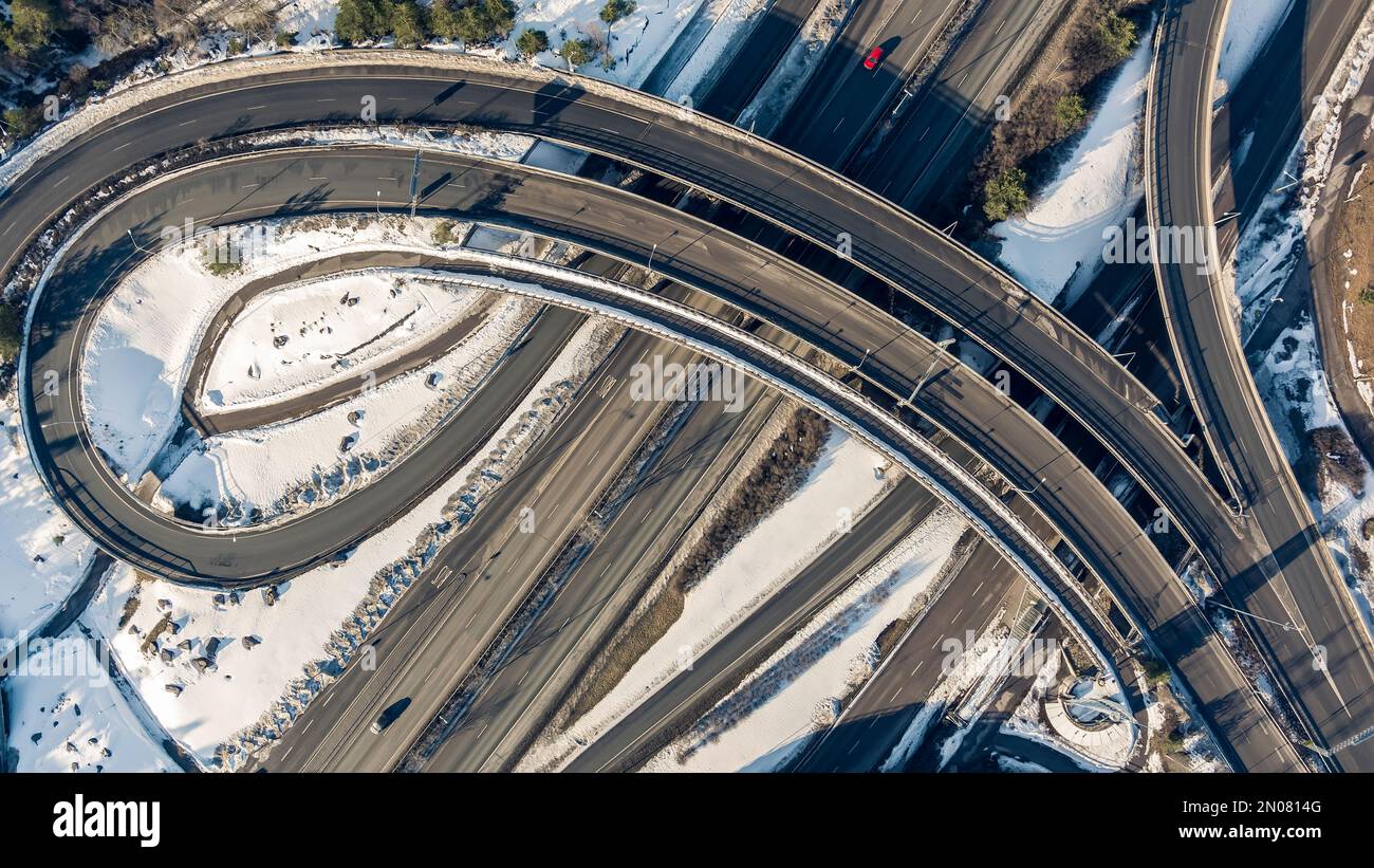 Aerial view of a freeway intersection Snow-covered in winter. Busy ...