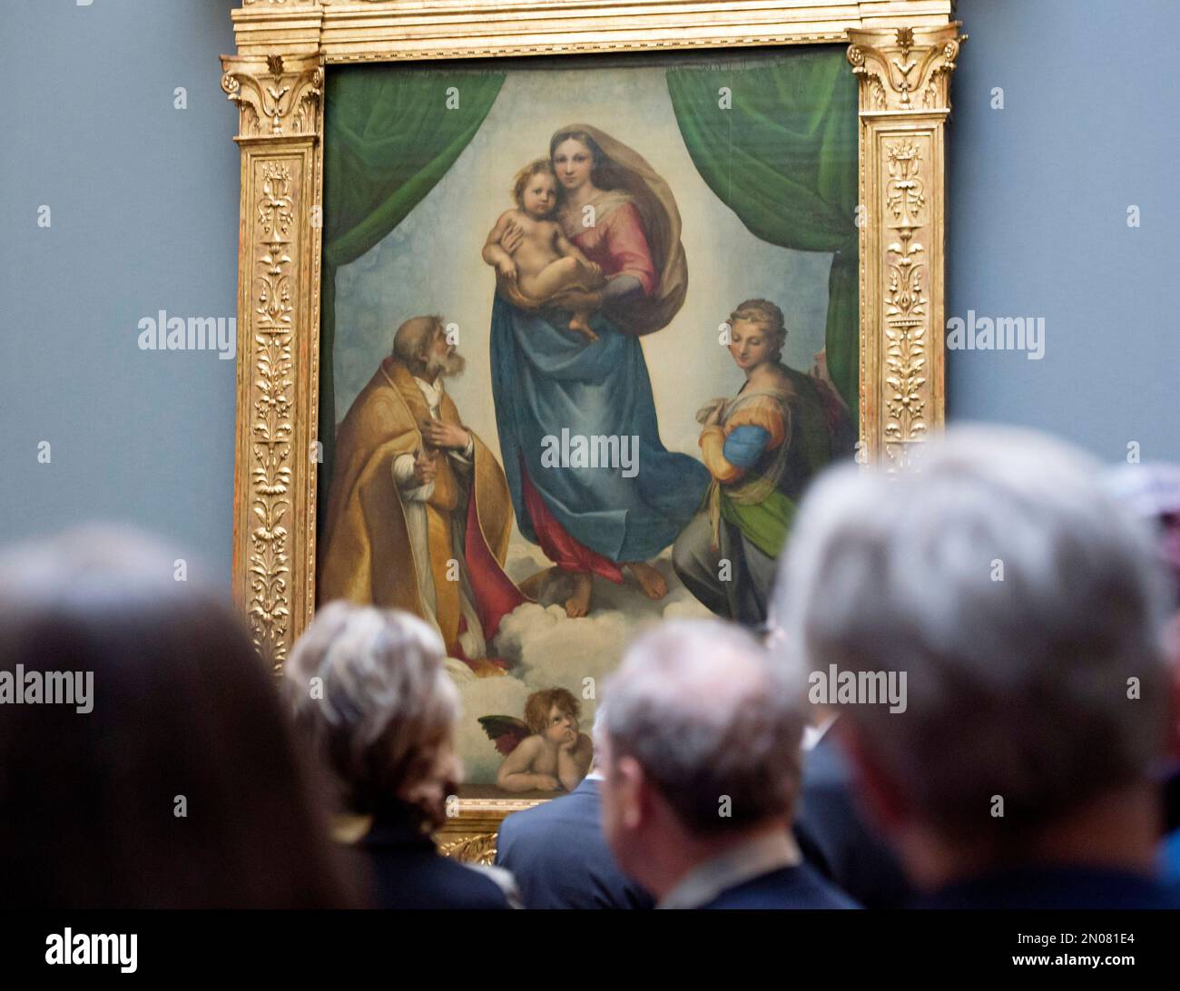 Visitors stand in front of the painting 'The Sistine Madonna' by ...
