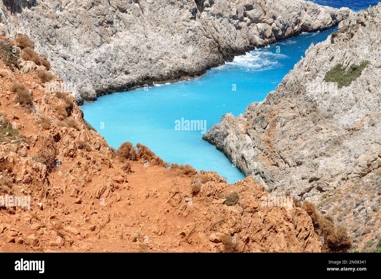 Little lagoon between the steep cliffs of the peninsula - Crete Island ...
