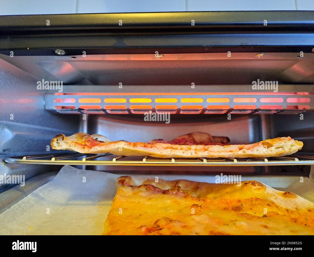 Slice of cheese pizza close-up real life in the kitchen, reheat in the ...