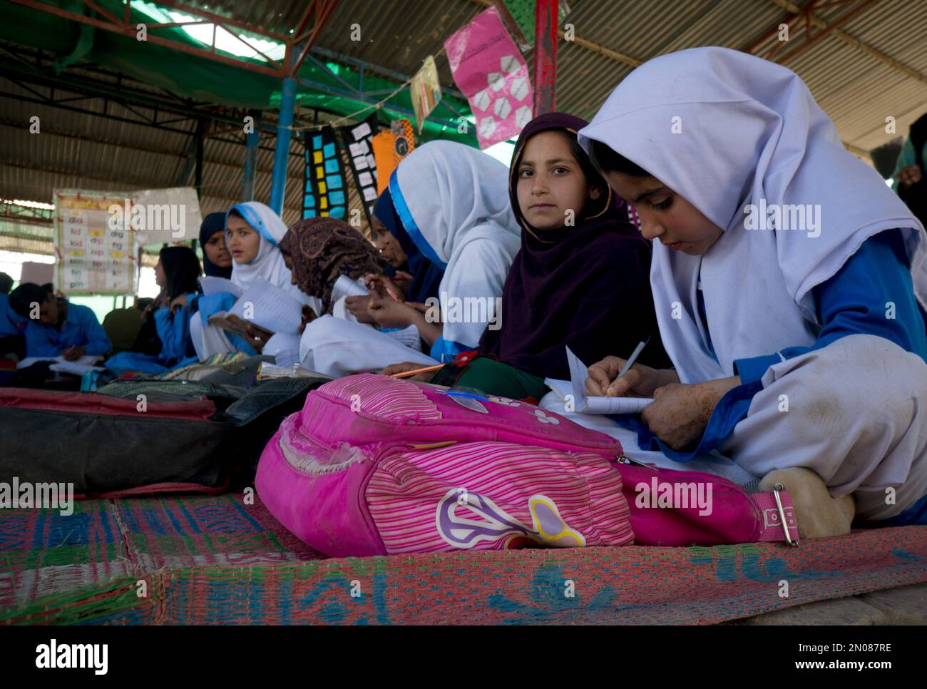 Pakistani students from poor families attend a makeshift school set up ...