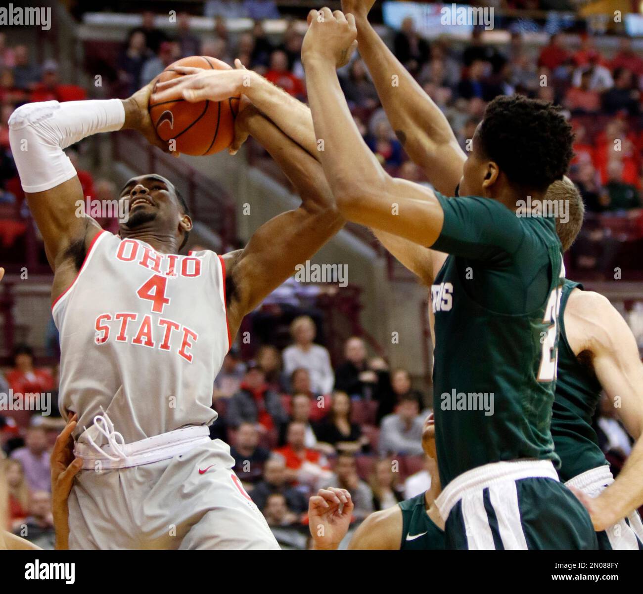 Ohio State's Daniel Giddens, left, works against Michigan State's ...