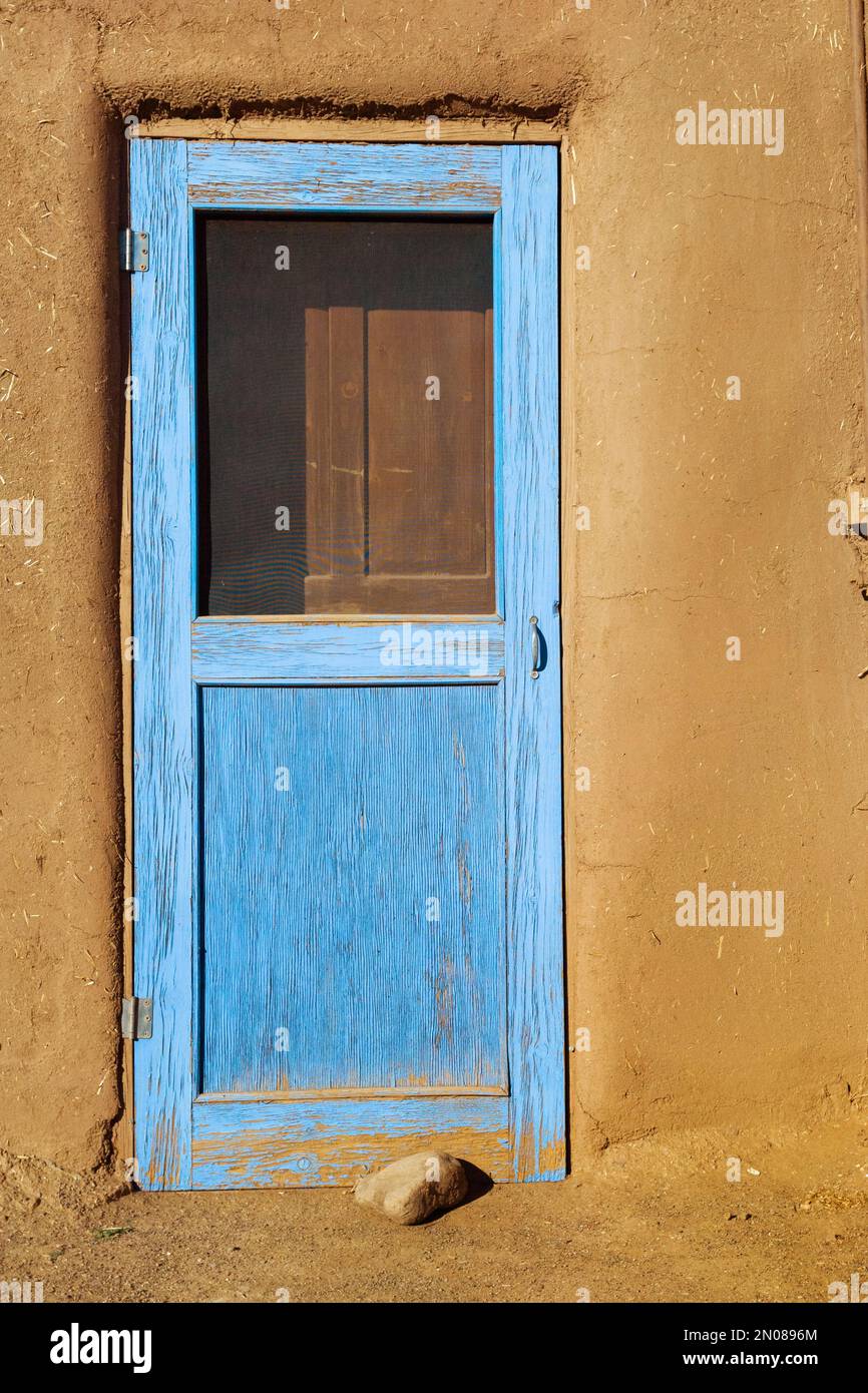 Traditional blue door, painted for protection, in ancient Taos Pueblo ...
