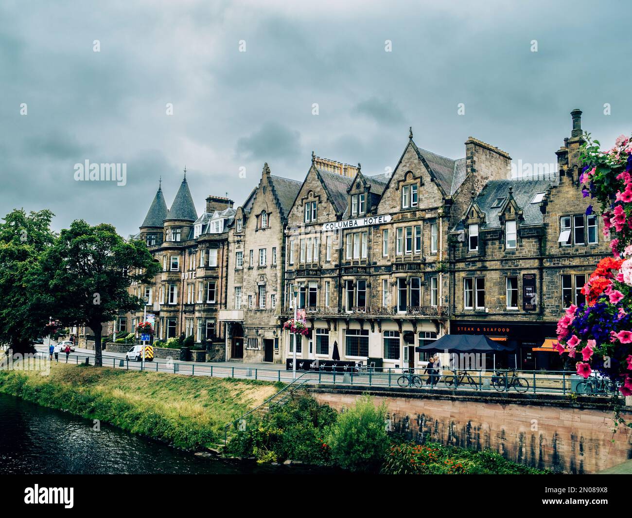Roadside embankment with hotel accommodation and restaurants by river ...