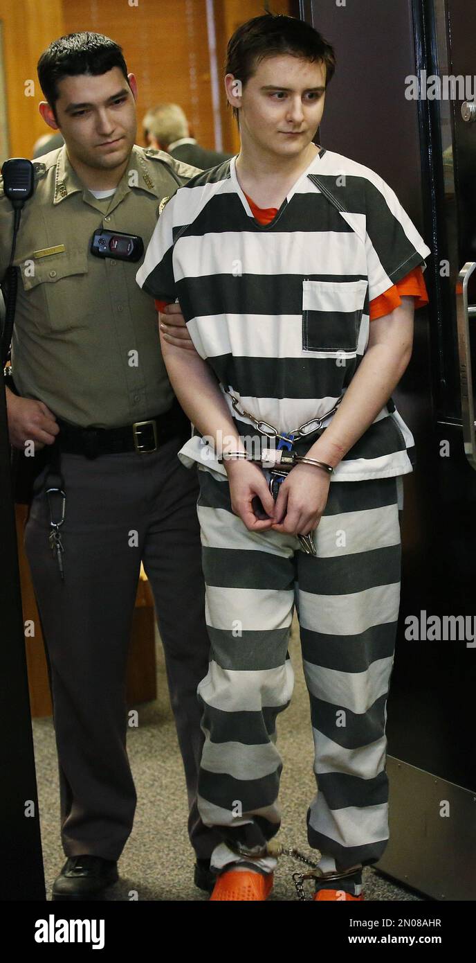 Robert Bever, right, in handcuffs and leg shackles, is led from a ...