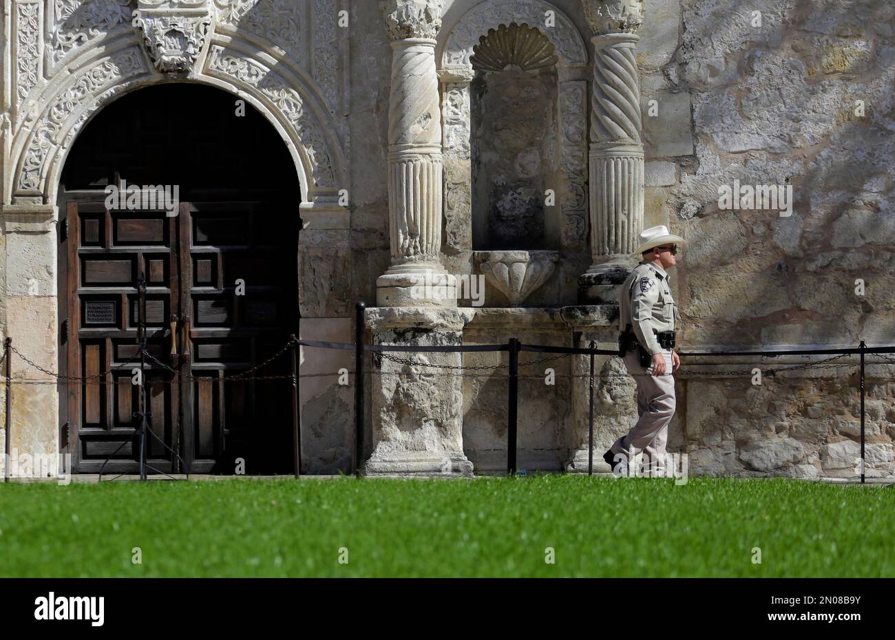 An Alamo Ranger walks the grounds of the shrine, Tuesday, Feb. 23, 2016 ...