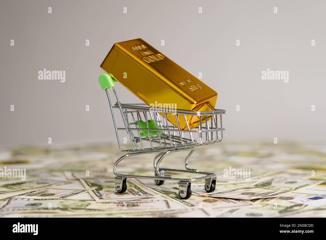 Gold bar in small shopping trolley cart. Online trading or buy gold ...