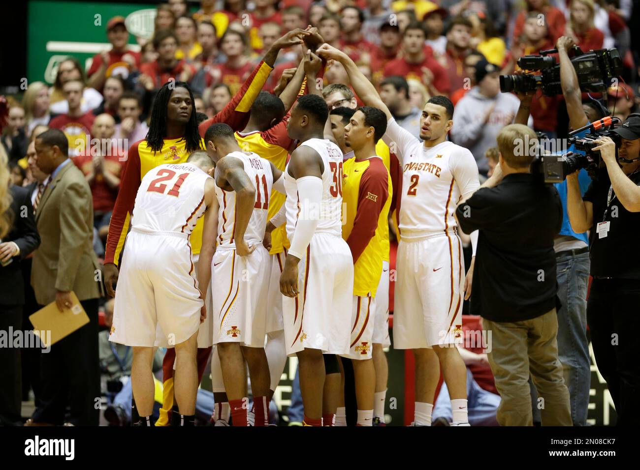 Iowa State players huddle on the court before an NCAA college ...