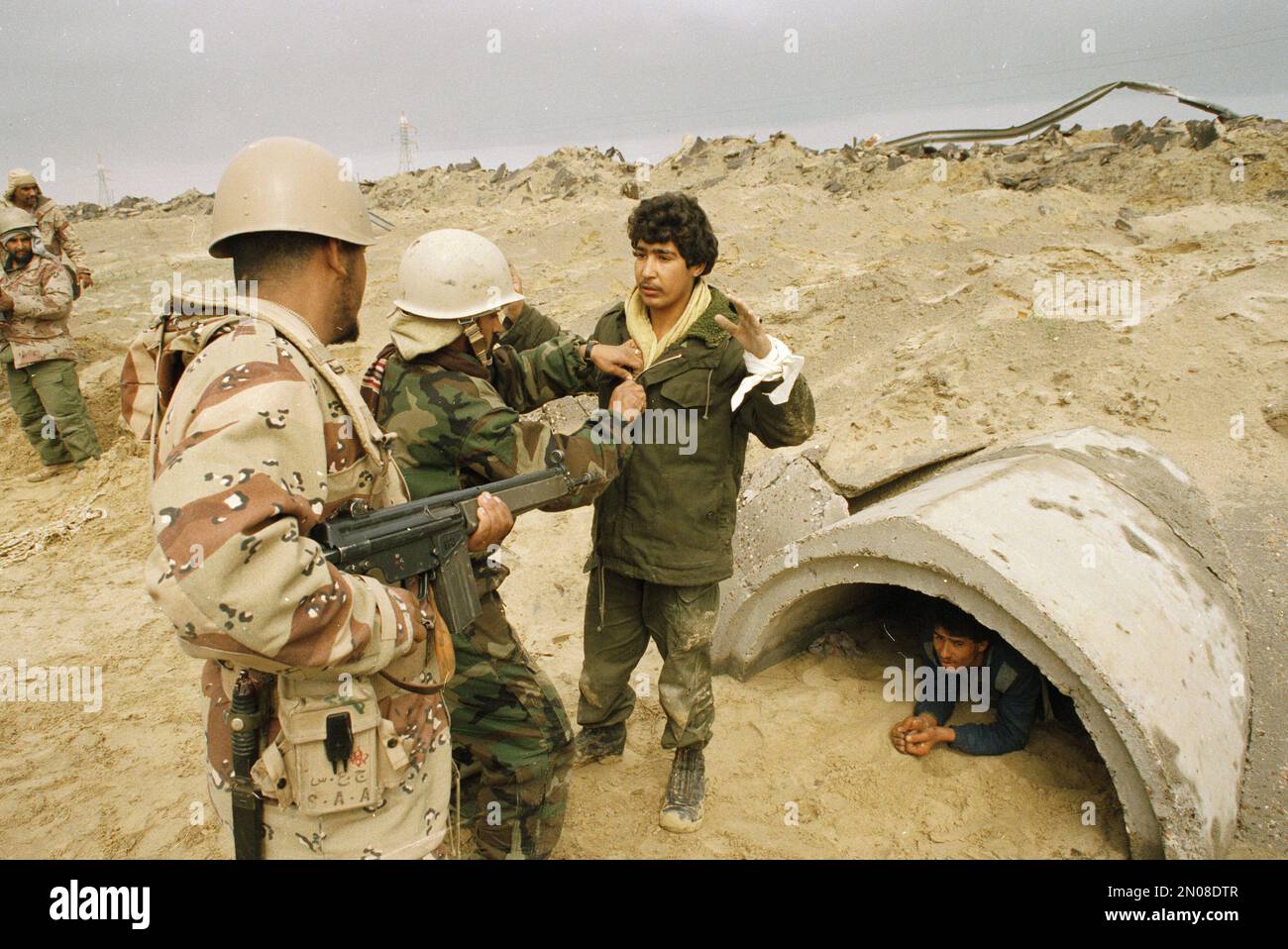 FILE - In this Monday, Feb. 25, 1991 file photo, Iraqi troops emerge ...