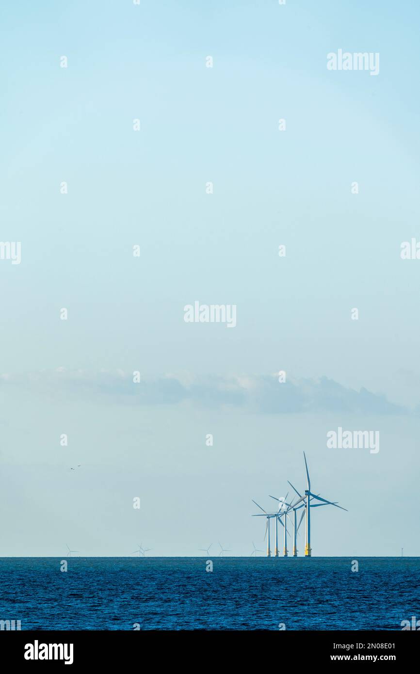 Row of wind turbines in the sea, with others on the horizon part of the ...