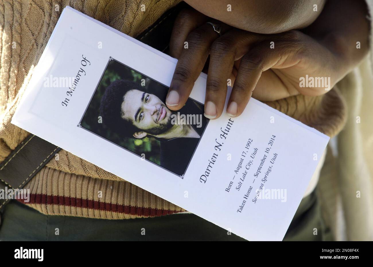 FILE - In this Sept. 18, 2014 file photo, a mourner holds the funeral ...