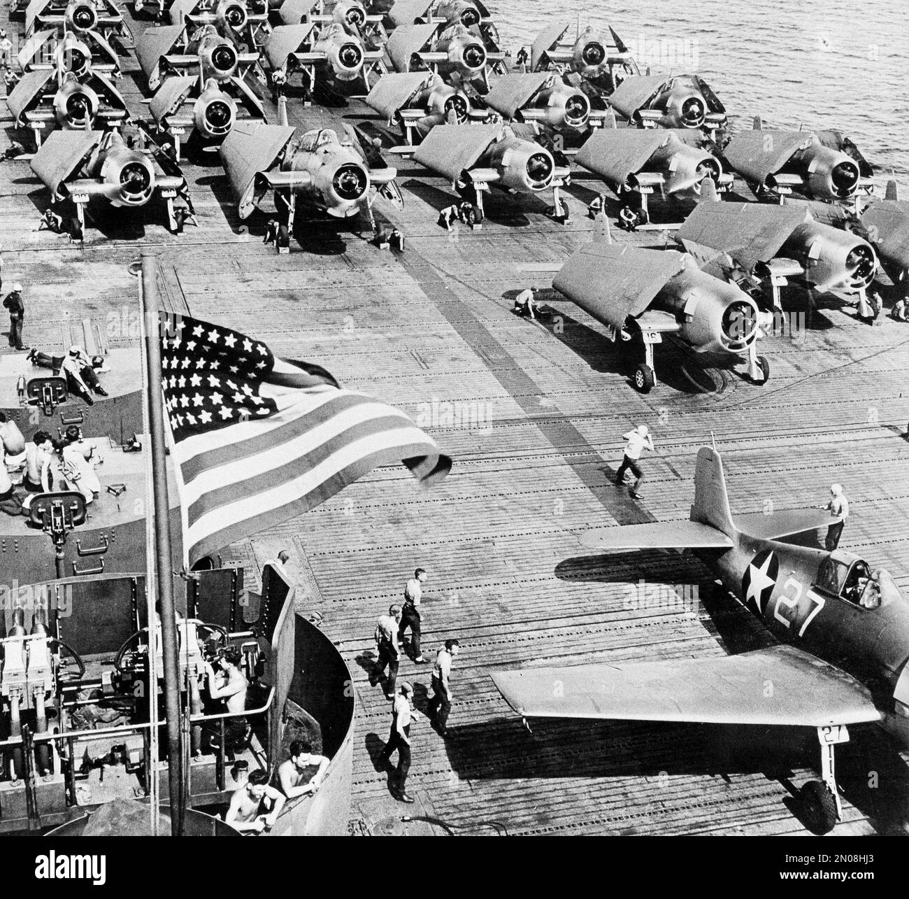 In this handout from the U.S. Navy, the flag whips in the breeze above ...