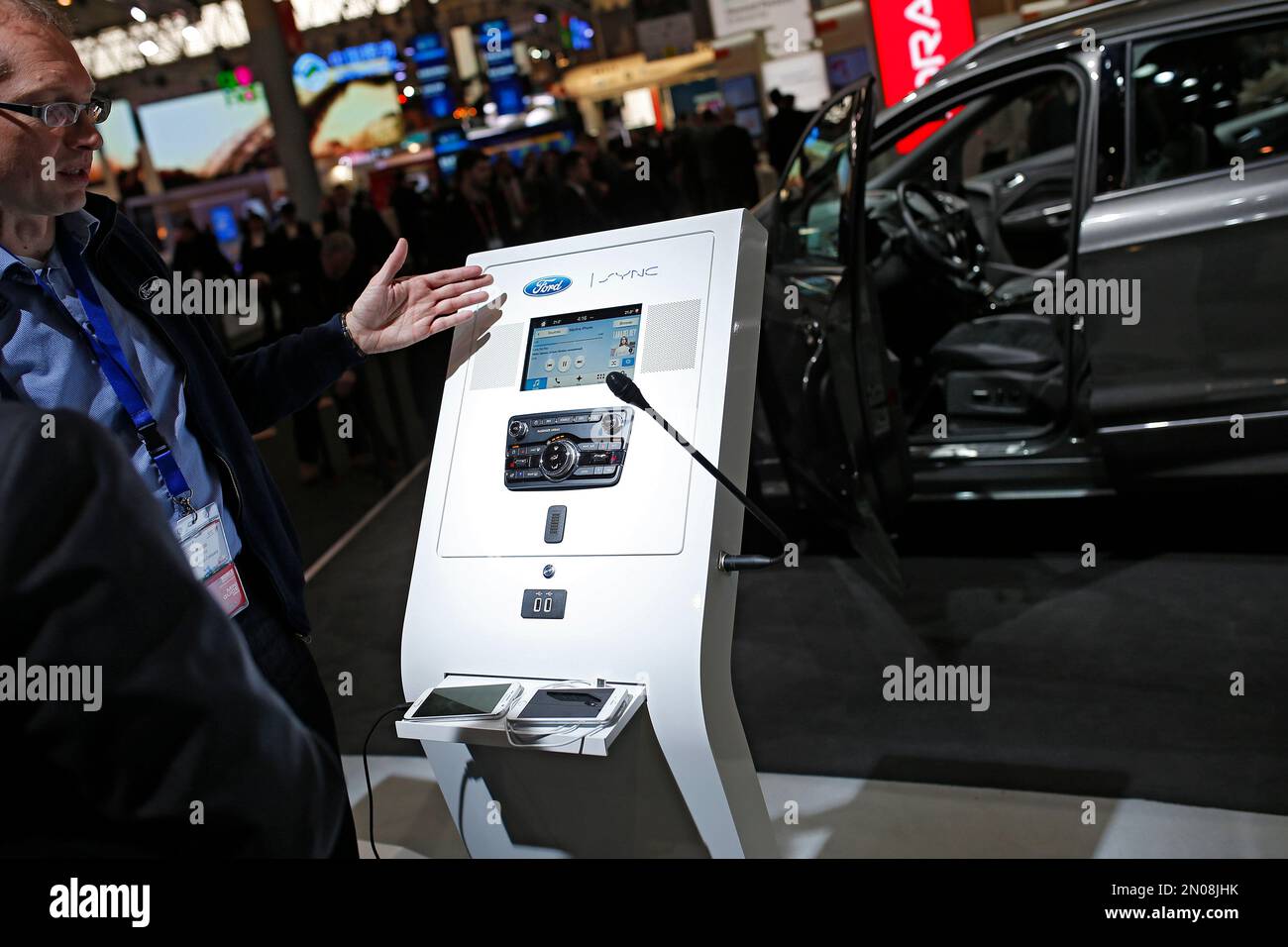 A Ford worker talks to a visitor about the new Ford Kuga SUV features ...