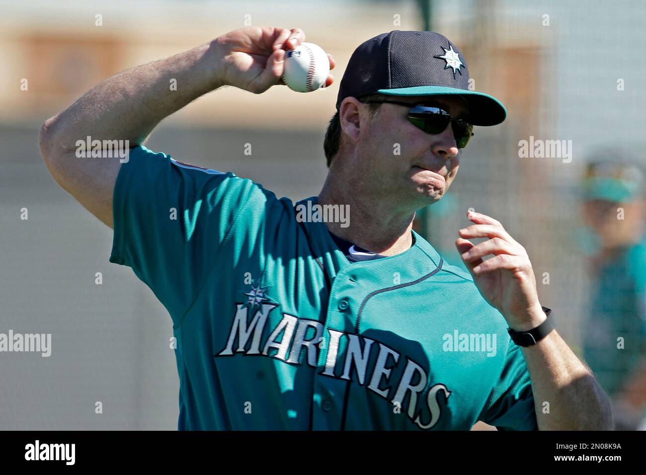 Seattle Mariners manager Scott Servais throws batting practice during ...