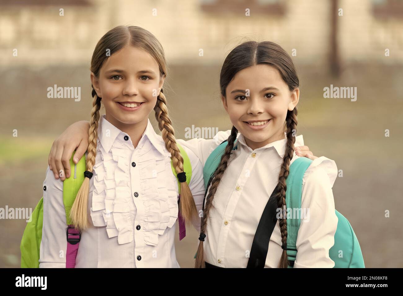 happy children hug together in school uniform with backpack Stock Photo ...