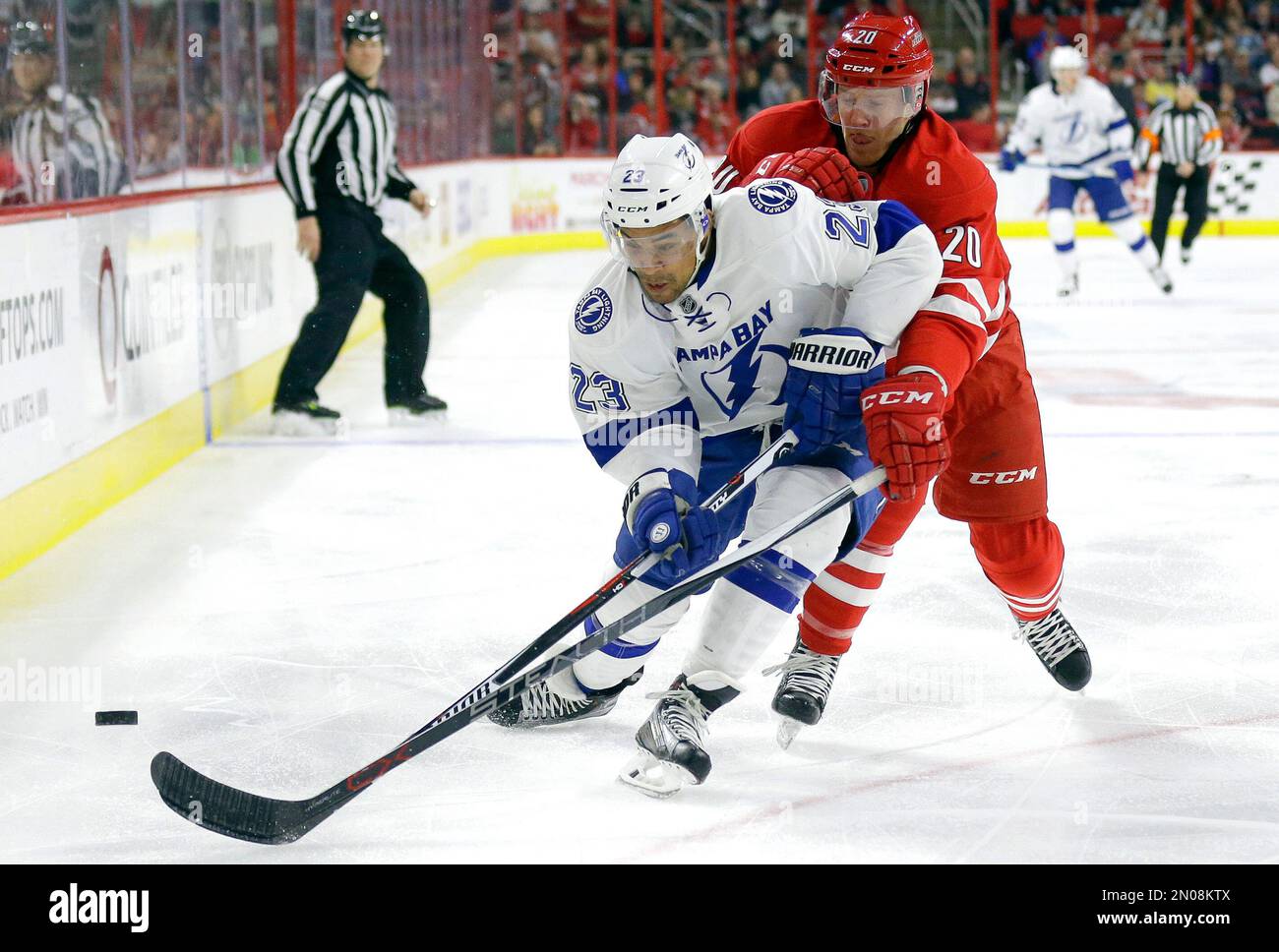 Carolina Hurricanes' Riley Nash (20) reaches around Tampa Bay Lightning ...