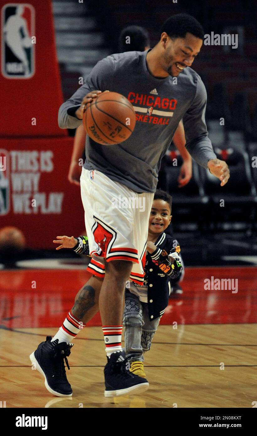 Chicago Bulls' Derrick Rose plays with his son P.J. Rose, 3, before an ...