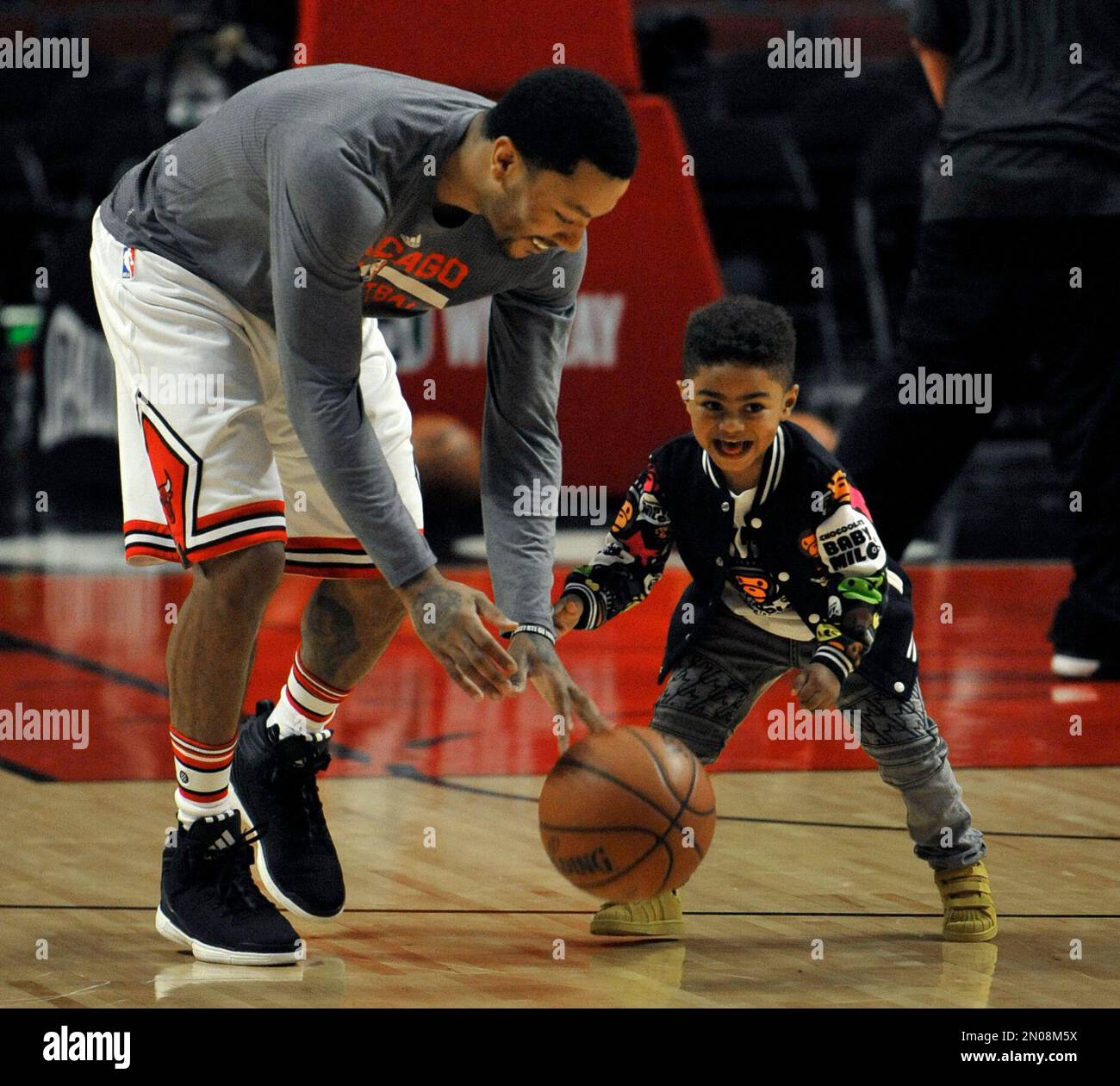 Chicago Bulls' Derrick Rose plays with his son P.J. Rose 3, before an ...