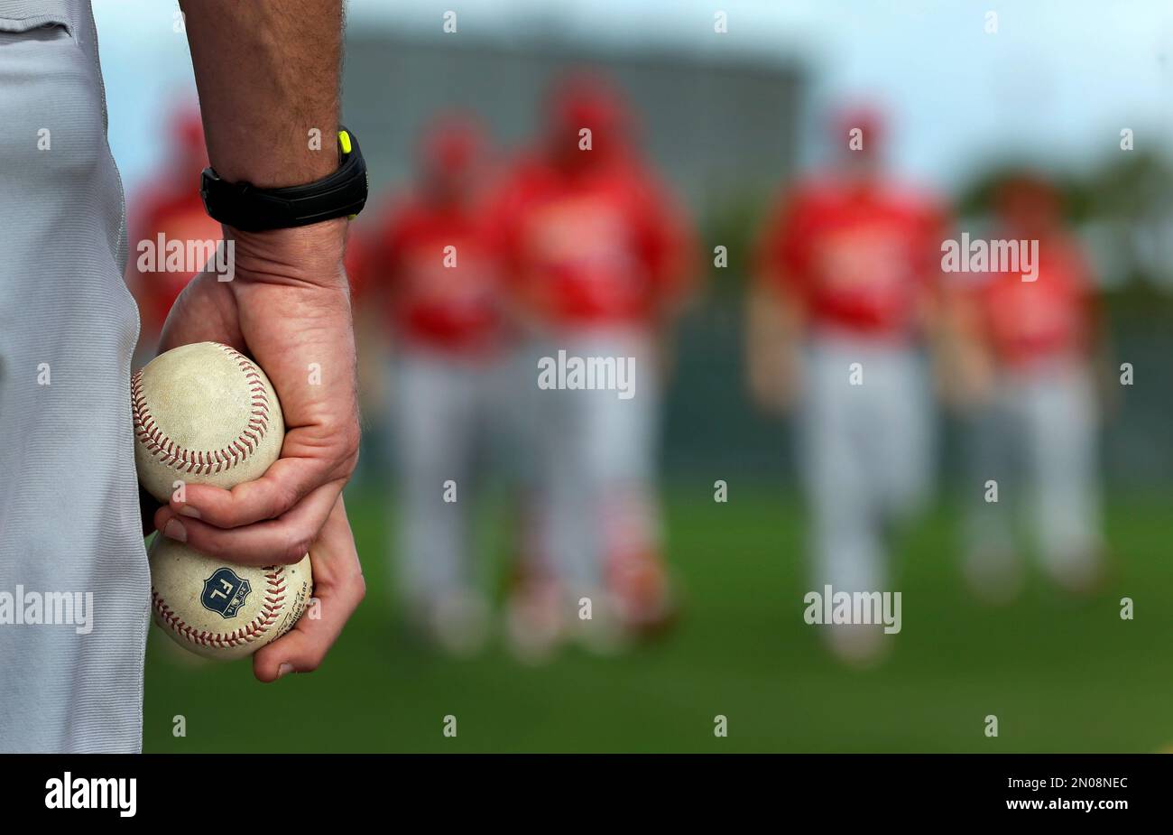 St. Louis Cardinals bullpen coach Blaise Ilsley holds baseballs as he ...