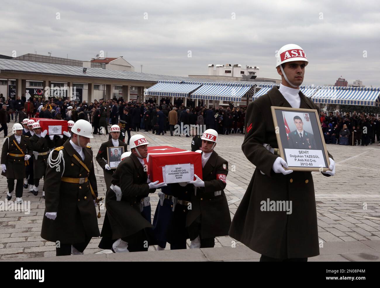 Honour guard carry the coffins of army officers Enes Demir and Dogukan ...
