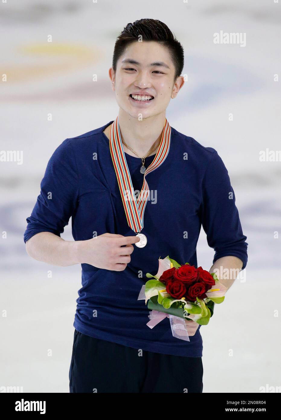Third place medal winner Yan Han of China displays his bronze medal ...