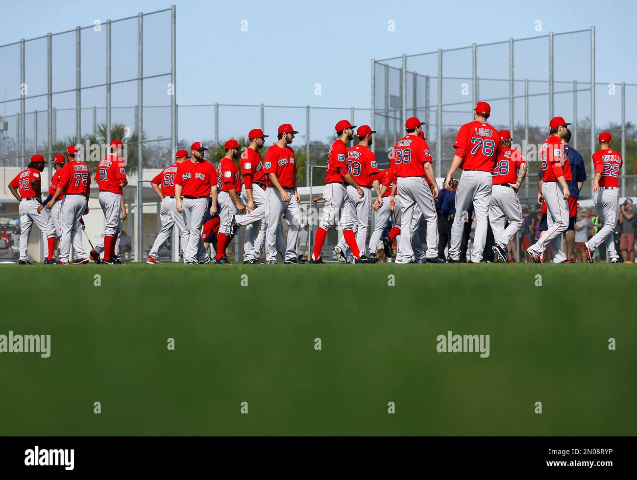 Members of the Boston Red Sox warm up before a spring training baseball ...