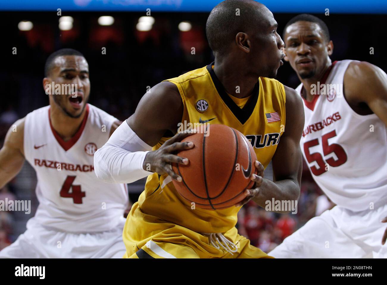 Missouri's Terrence Phillips, center, looks for a way around Arkansas ...