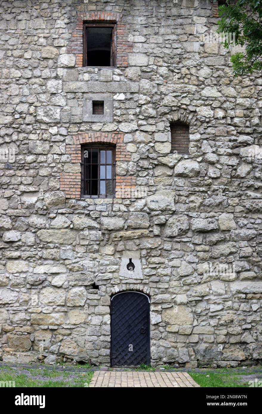 Ancient fortress stone wall with small door and windows Stock Photo - Alamy