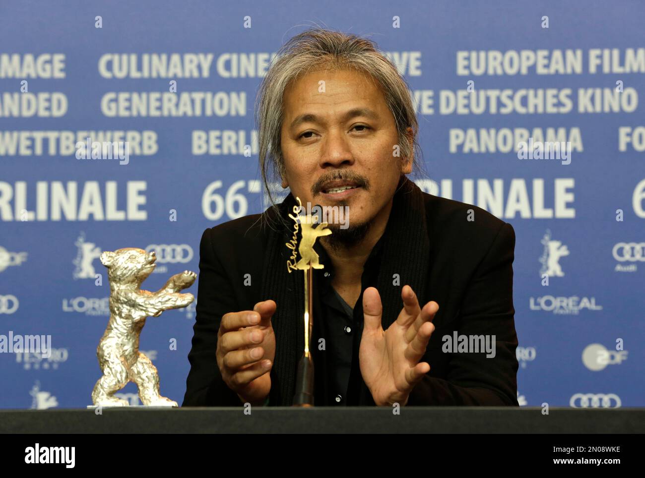 Lav Diaz, director of 'Hele Sa Hiwagang Hapis' speaks beside his Silver ...