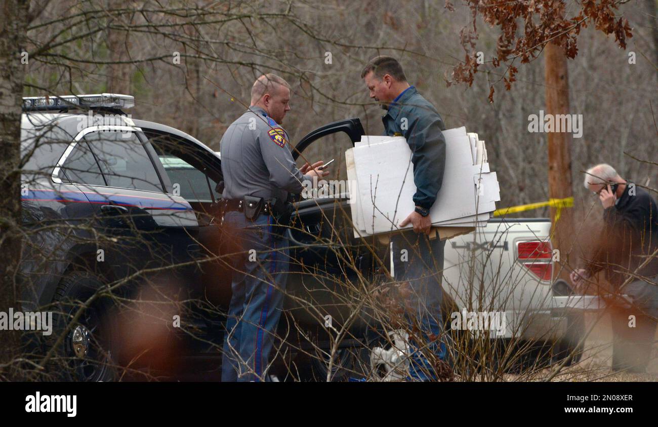 Officers investigate the scene of a shooting near Iuka, Miss., Saturday ...