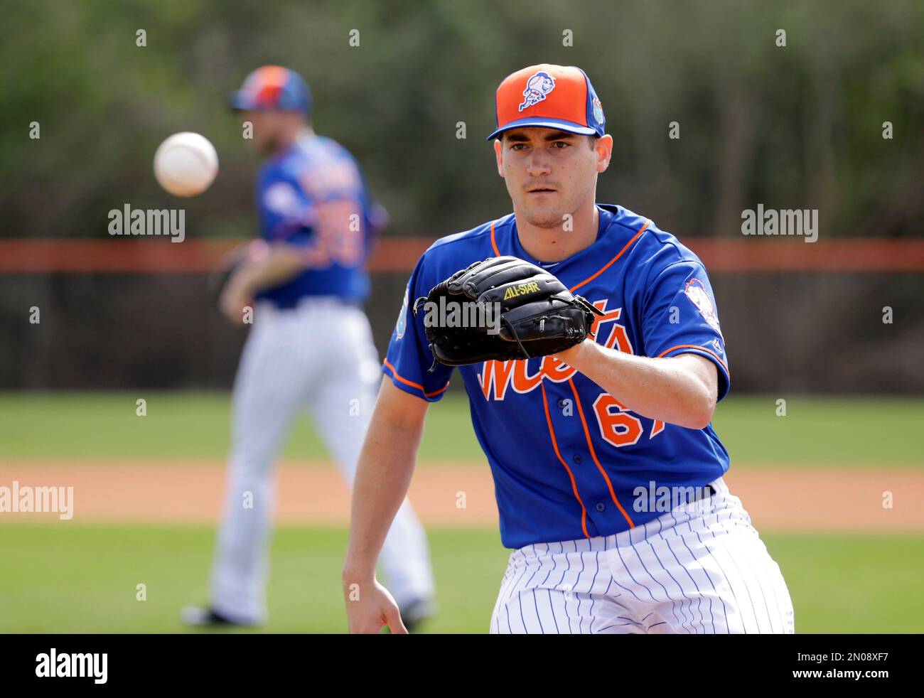 New York Mets pitcher Seth Lugo catches a ball during spring training ...