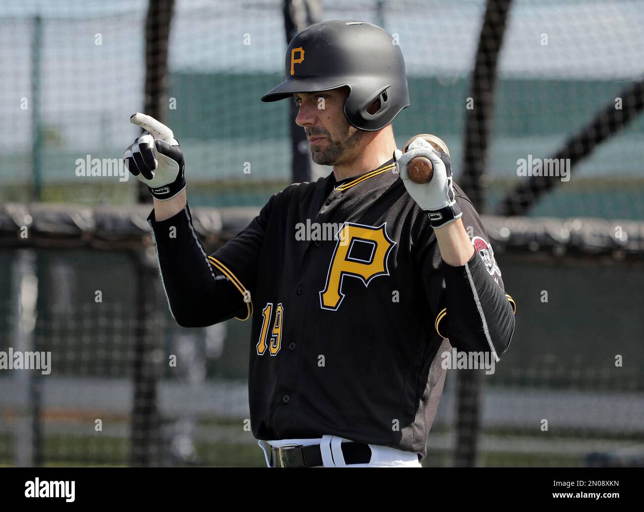 Pittsburgh Pirates catcher Chris Stewart points to the outfield fence ...