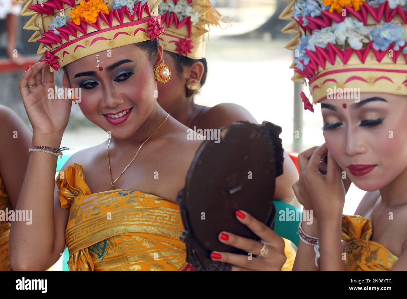 Balinese dancers prepare for their performance at Sakenan temple to ...