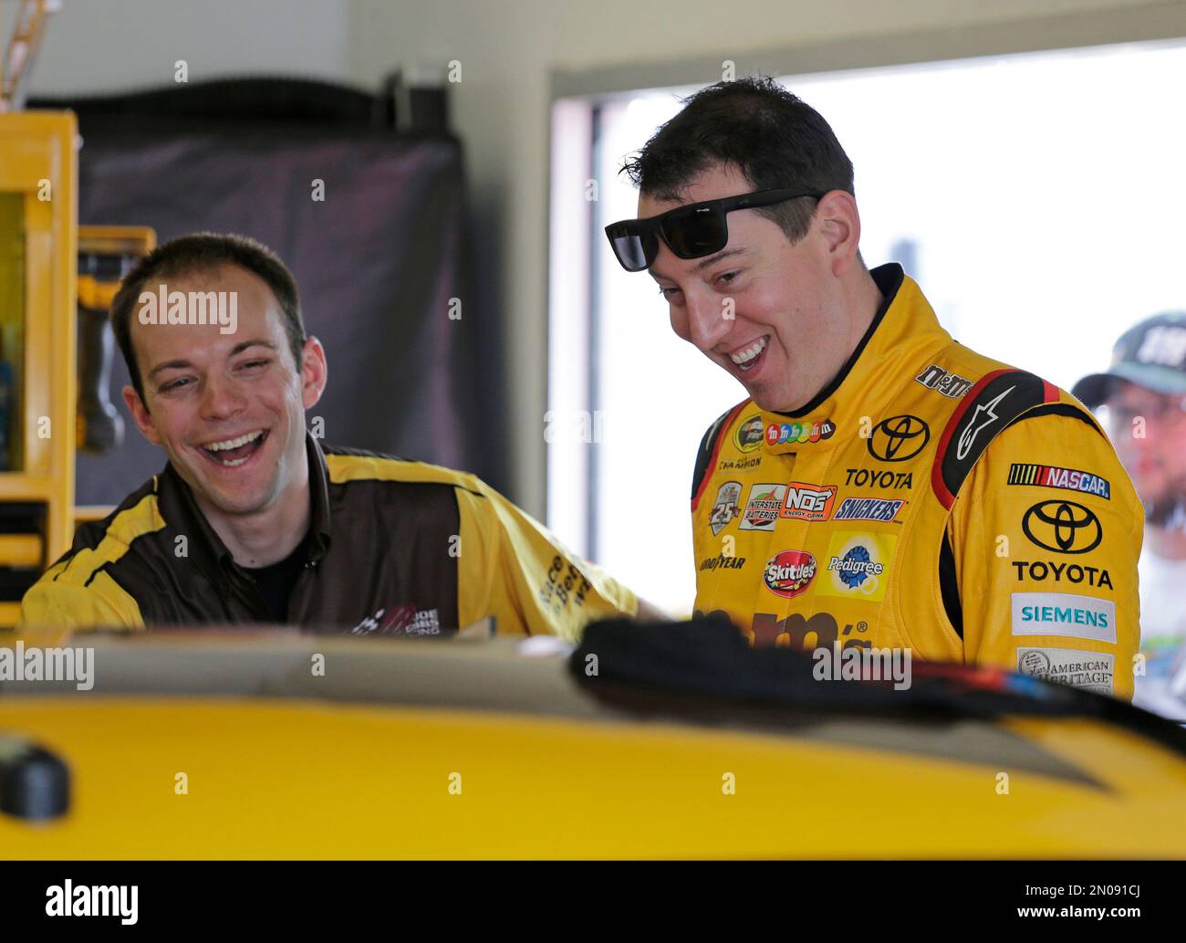 Kyle Busch, right, shares a laugh with a crew member during practice ...