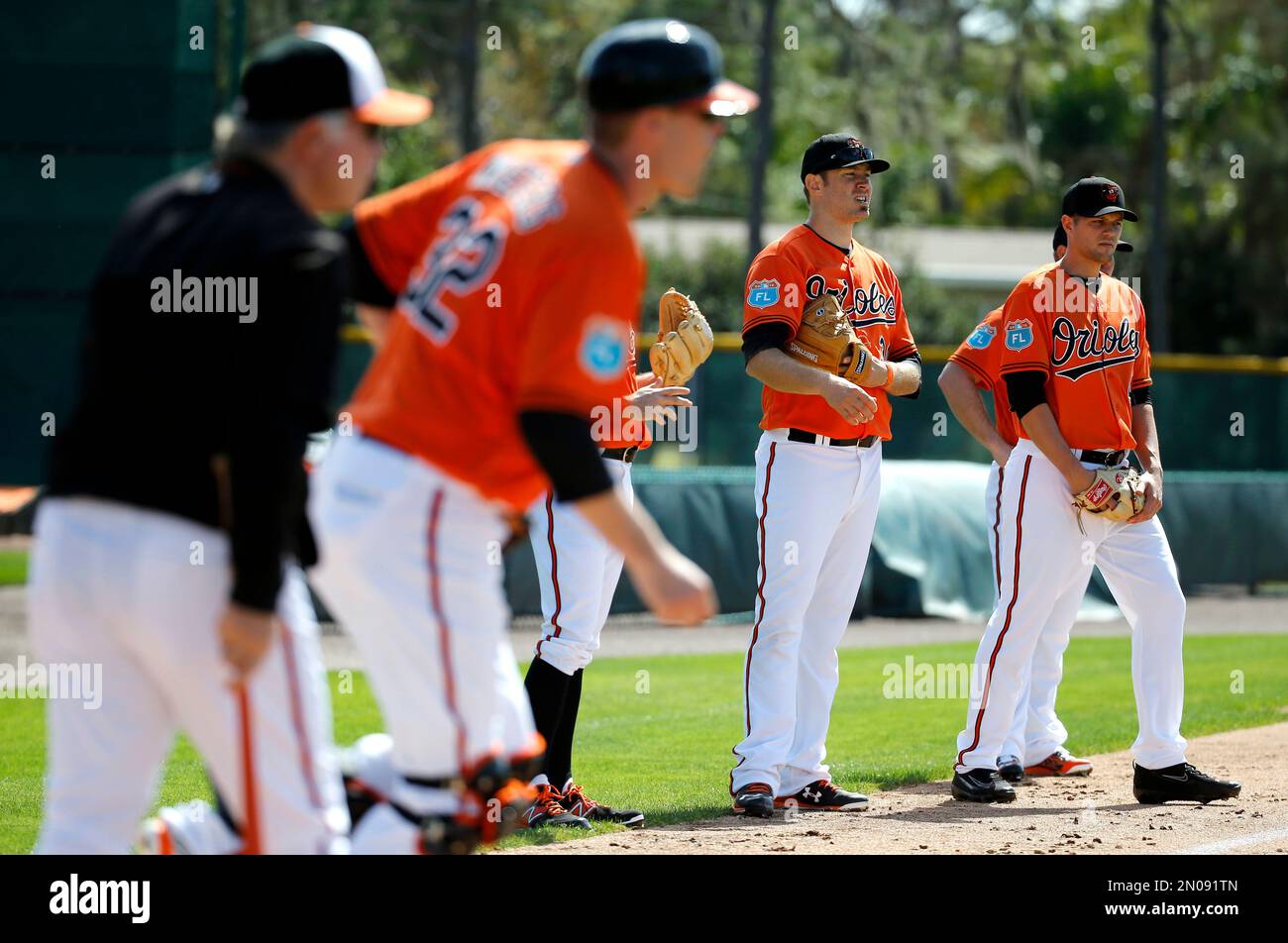 Baltimore Orioles pitcher Chris Tillman, second from right, watches a ...