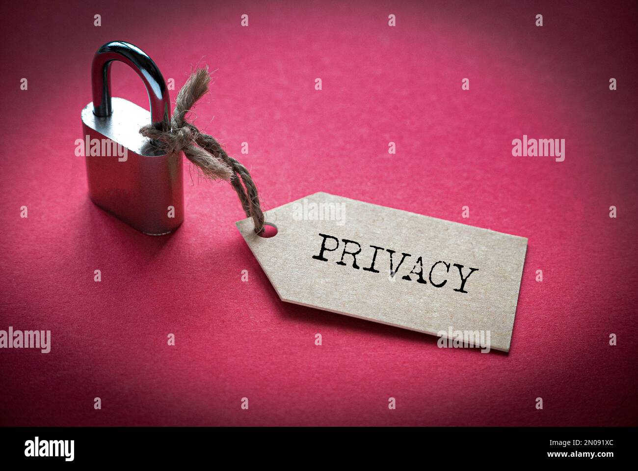 A padlock with number attached to a tag written with Privacy on red ...