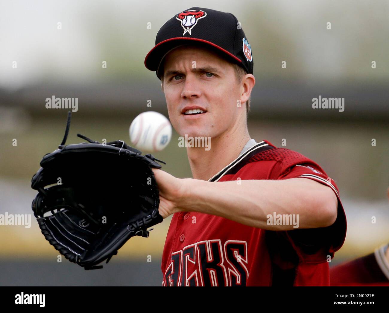 Arizona Diamondbacks pitcher Zack Greinke fields a ball during a spring baseball practice in ...