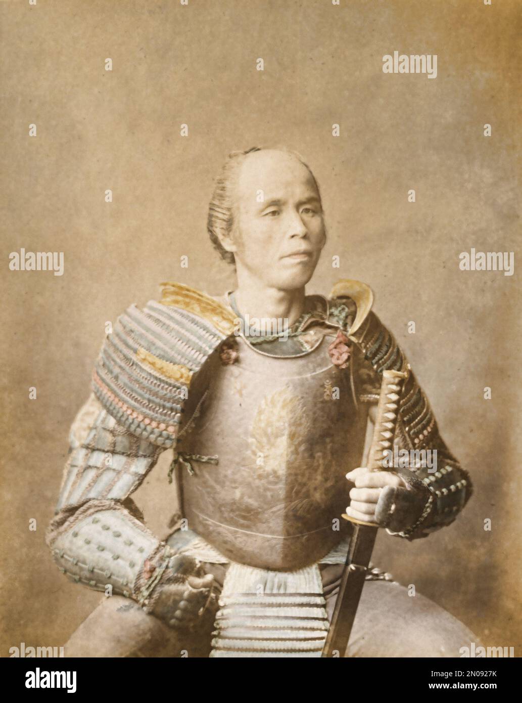 A photograph of a Japanese Samurai in traditional armor holding a ...