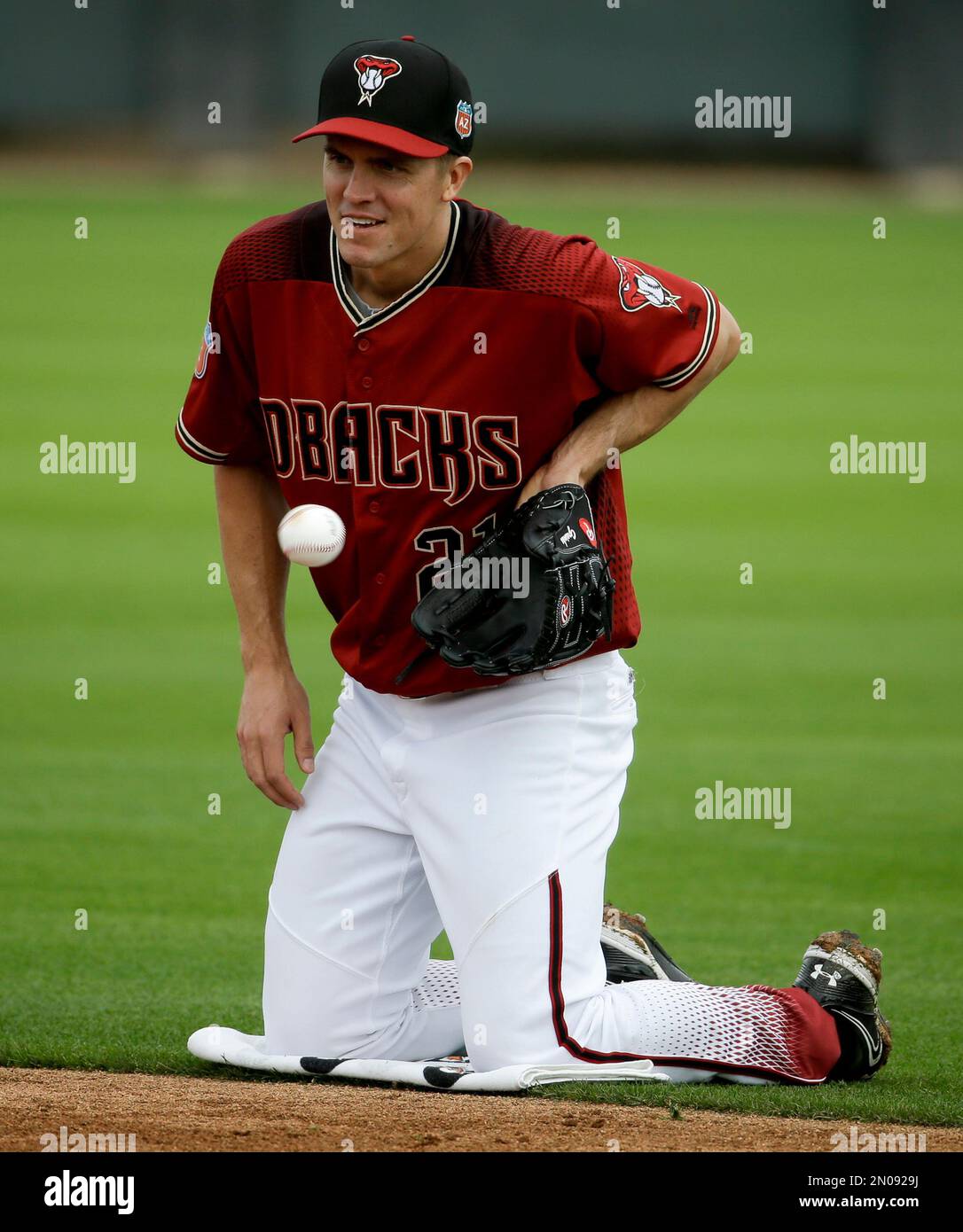 Arizona Diamondbacks pitcher Zack Greinke fields a ball during a spring baseball practice in ...
